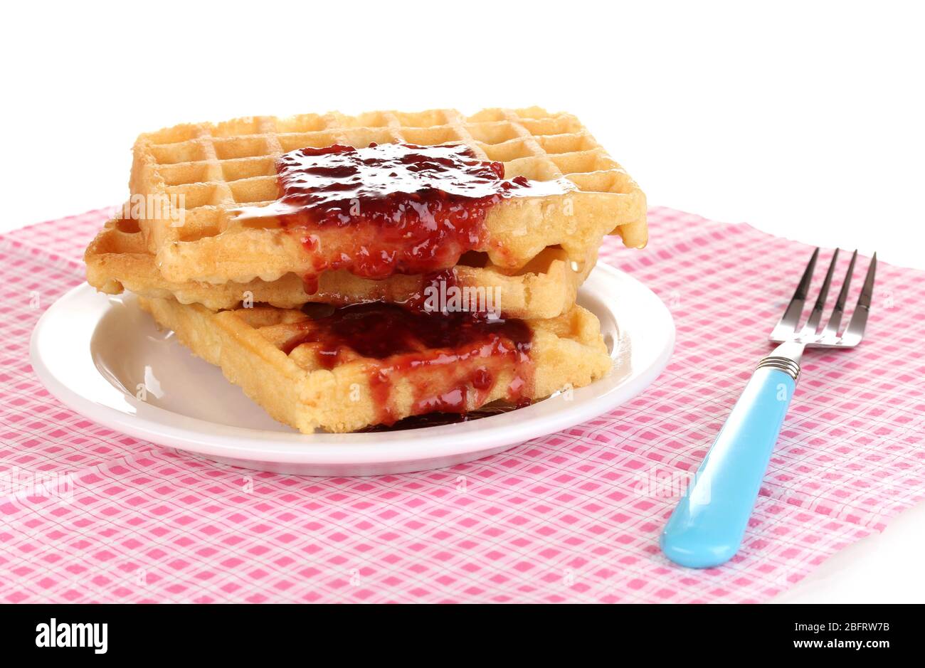 Tasty waffles with jam on plate isolated on white Stock Photo - Alamy