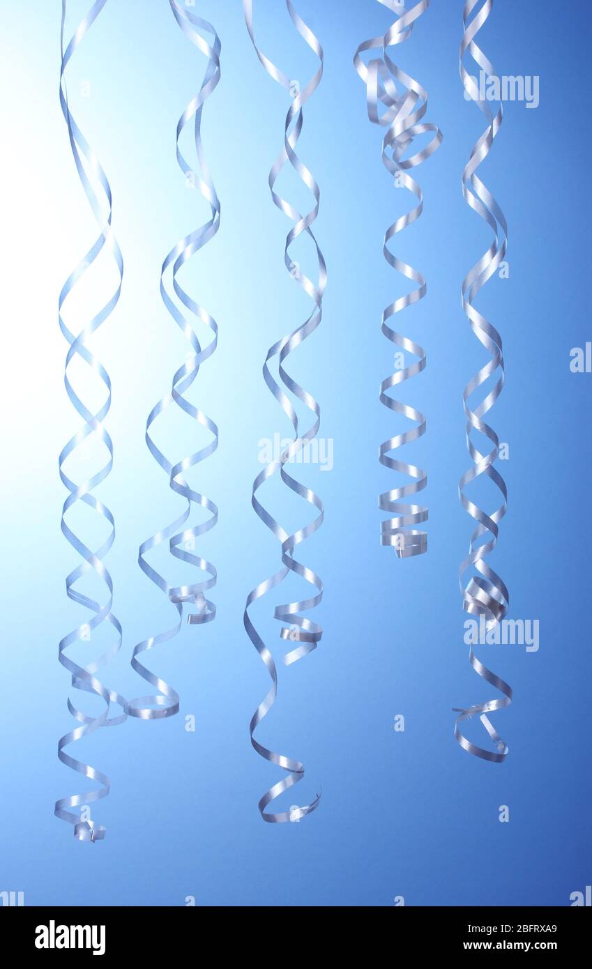 beautiful streamers on blue background Stock Photo - Alamy