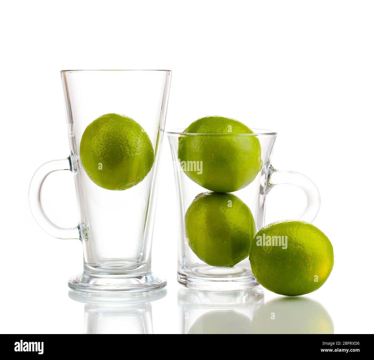 Fresh limes in glass cups isolated on white Stock Photo - Alamy