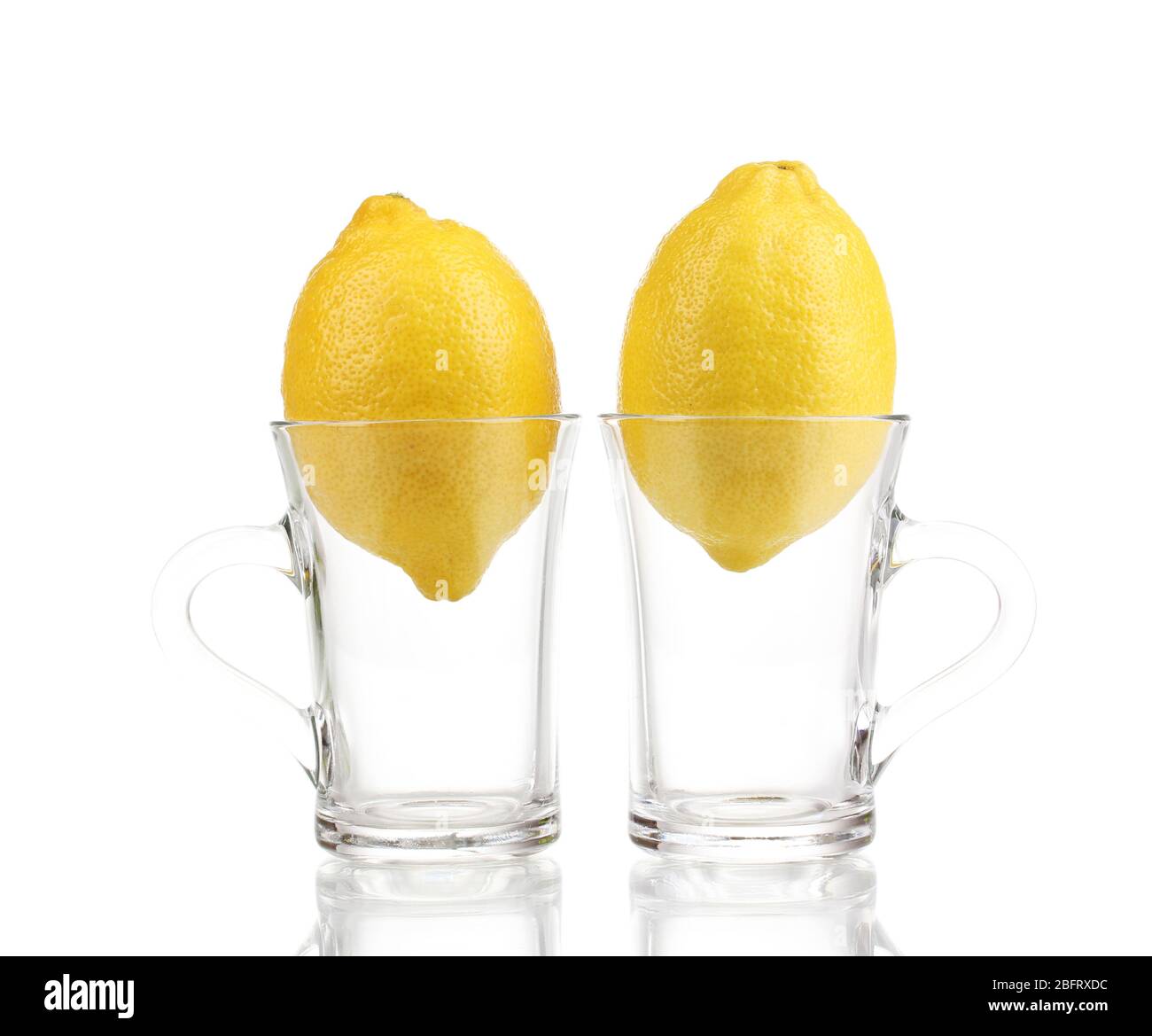 Fresh lemons in glass cups isolated on white Stock Photo - Alamy