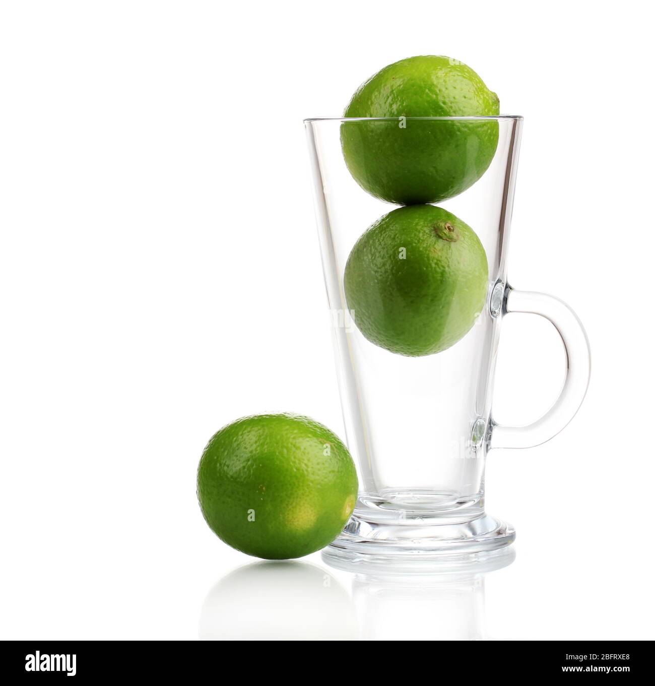 Fresh limes in glass cup isolated on white Stock Photo - Alamy