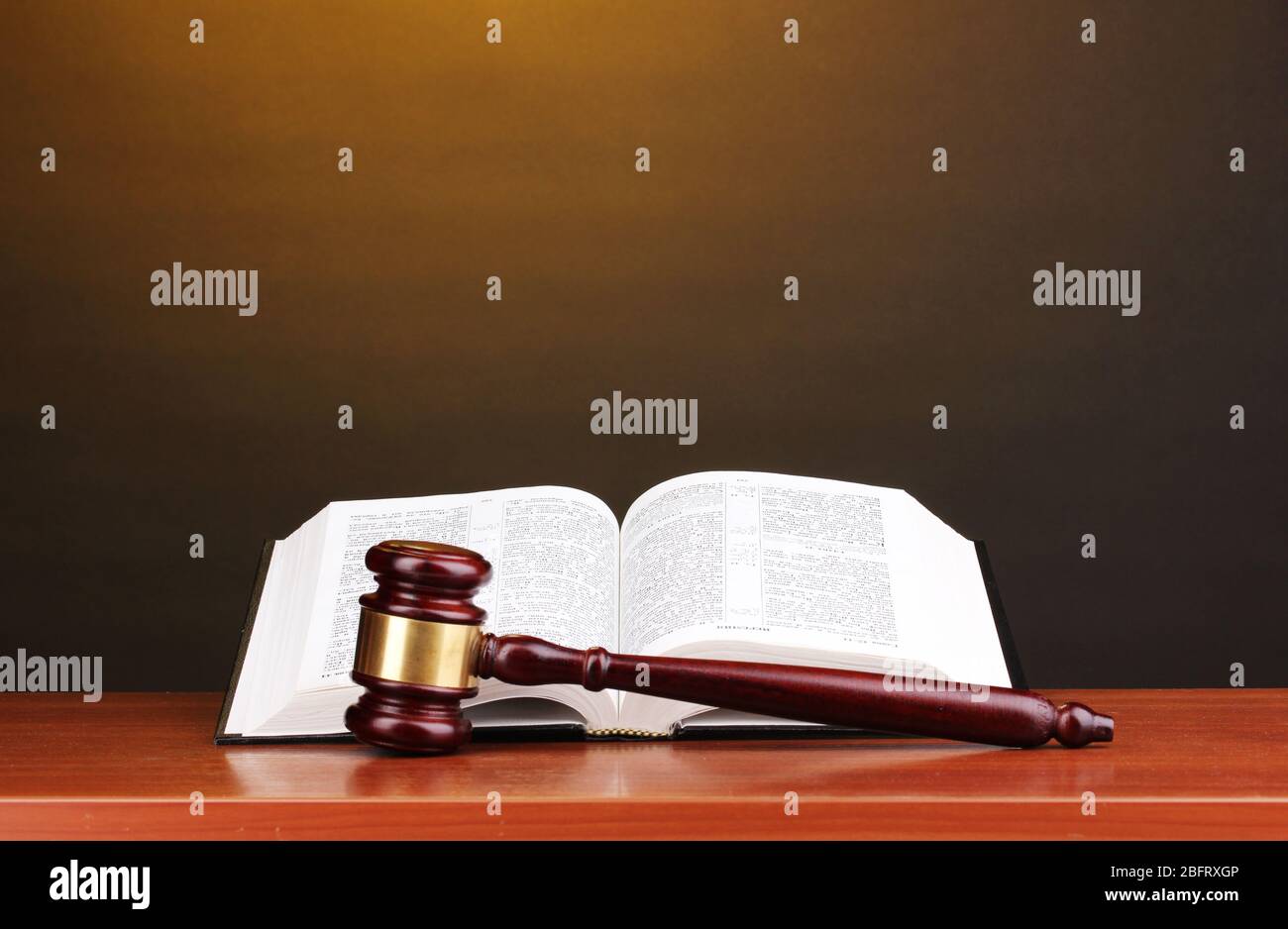 Judge's gavel and open book on wooden table on brown background Stock ...