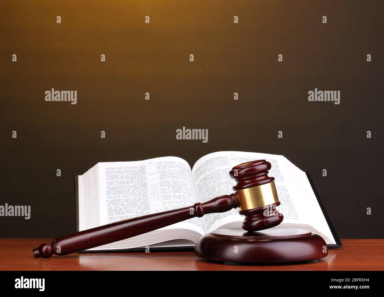 Judge's gavel and open book on wooden table on brown background Stock ...
