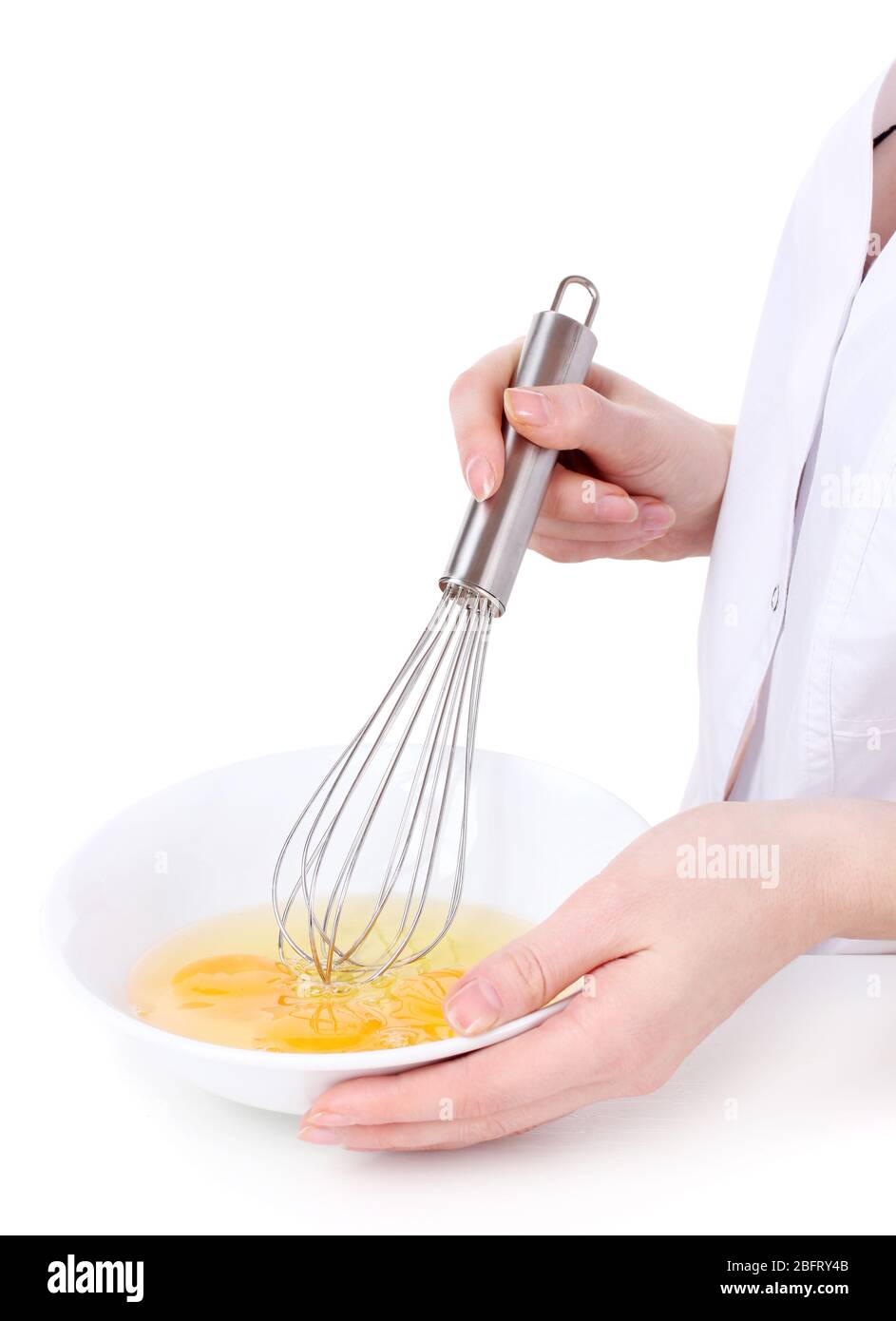 Female hands Mixing eggs in bowl isolated on white Stock Photo - Alamy