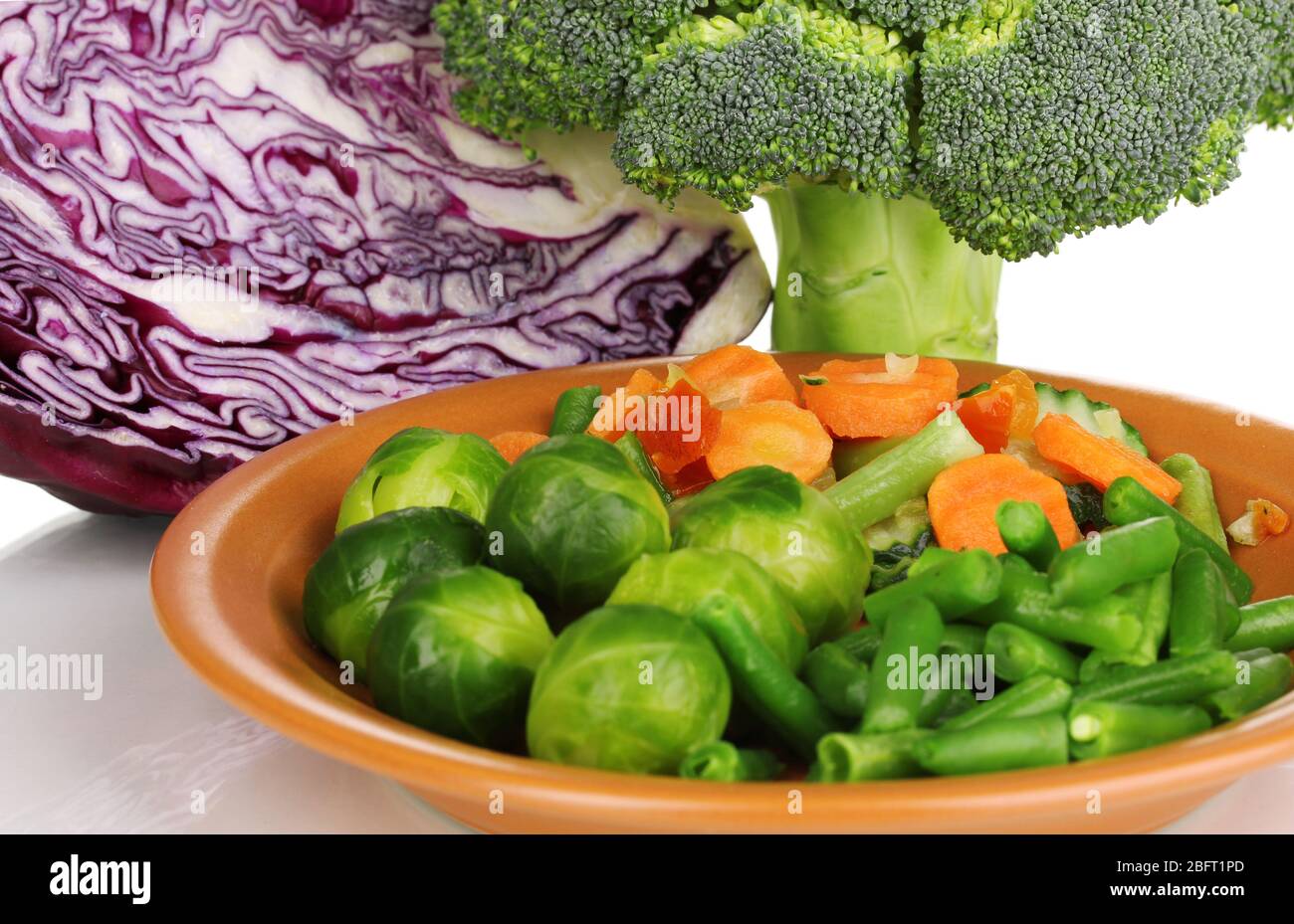 Mixed vegetables on plate close-up isolated on white Stock Photo - Alamy
