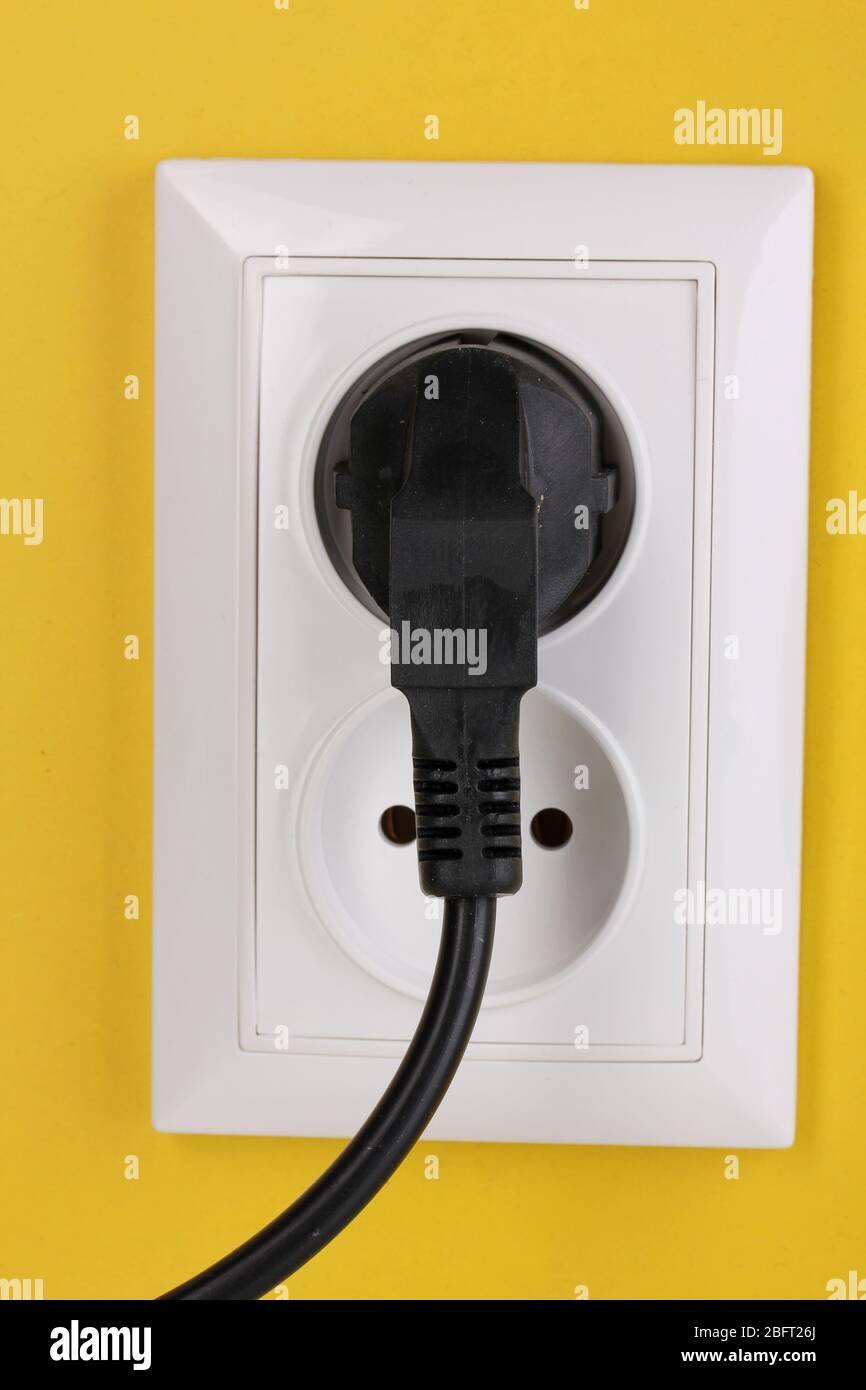 White electric socket with plug on the wall Stock Photo - Alamy