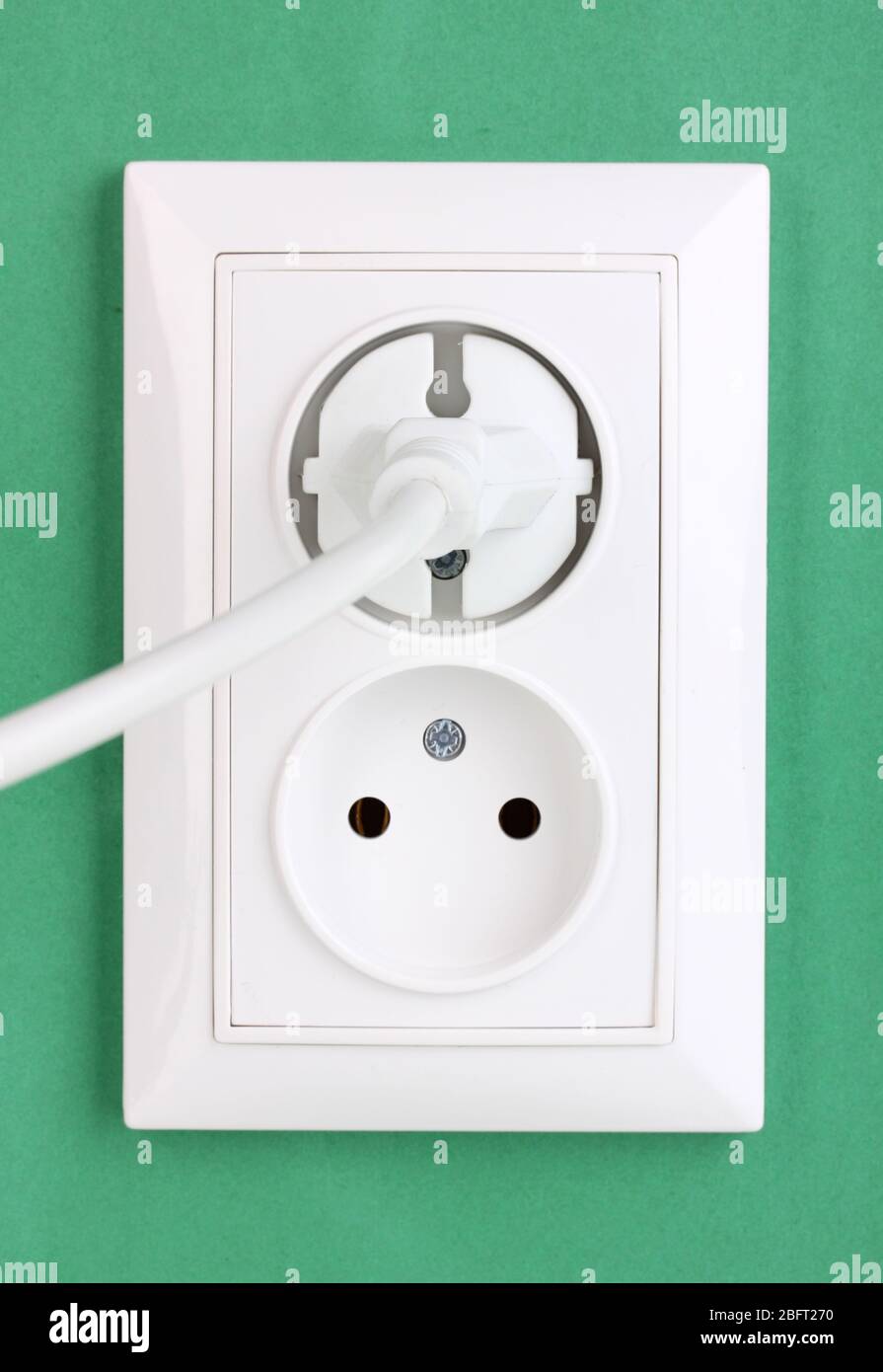 White electric socket with plug on the wall Stock Photo - Alamy