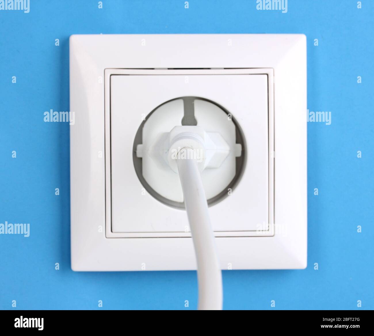 White electric socket with plug on the wall Stock Photo - Alamy
