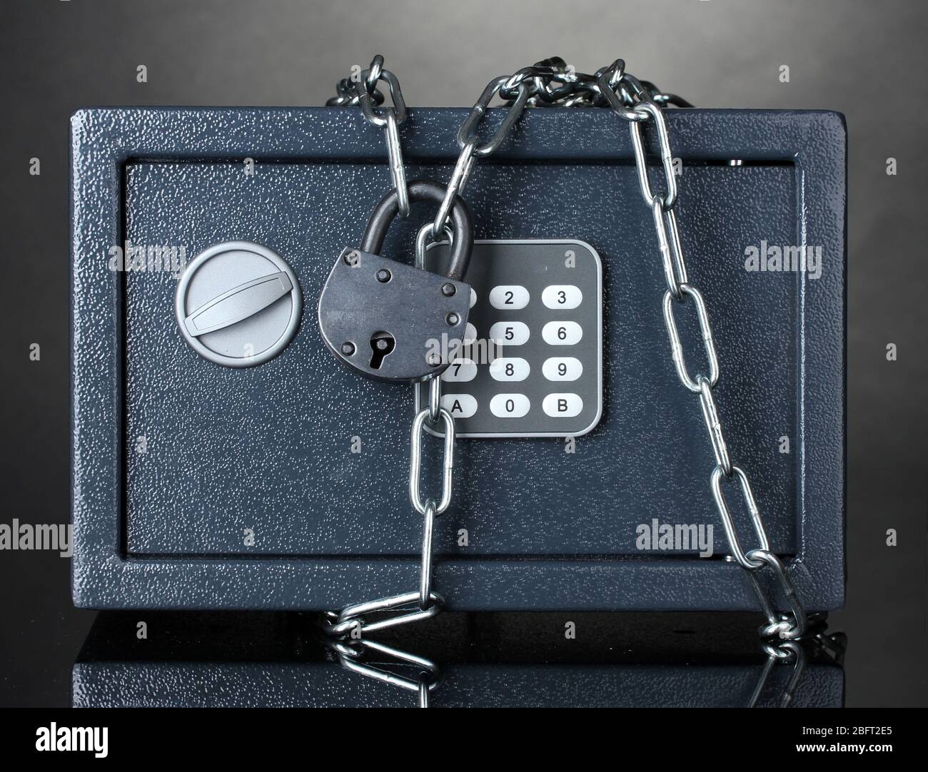 safe with chain and lock on grey background Stock Photo - Alamy