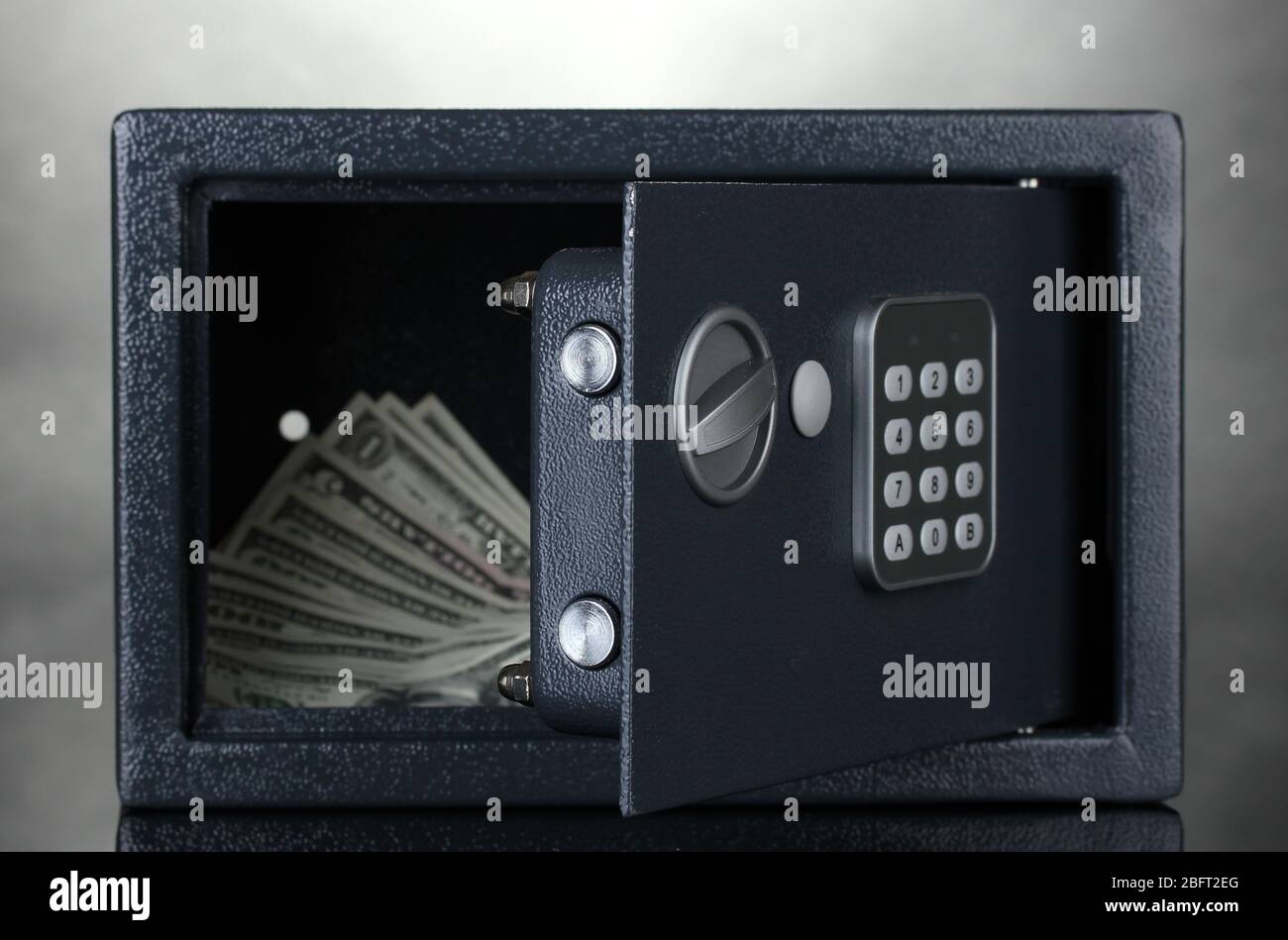 safe with dollars on grey background Stock Photo - Alamy