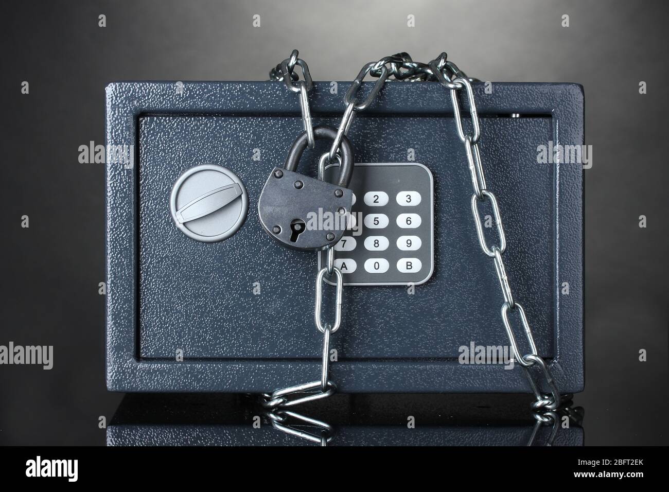 safe with chain and lock on grey background Stock Photo - Alamy