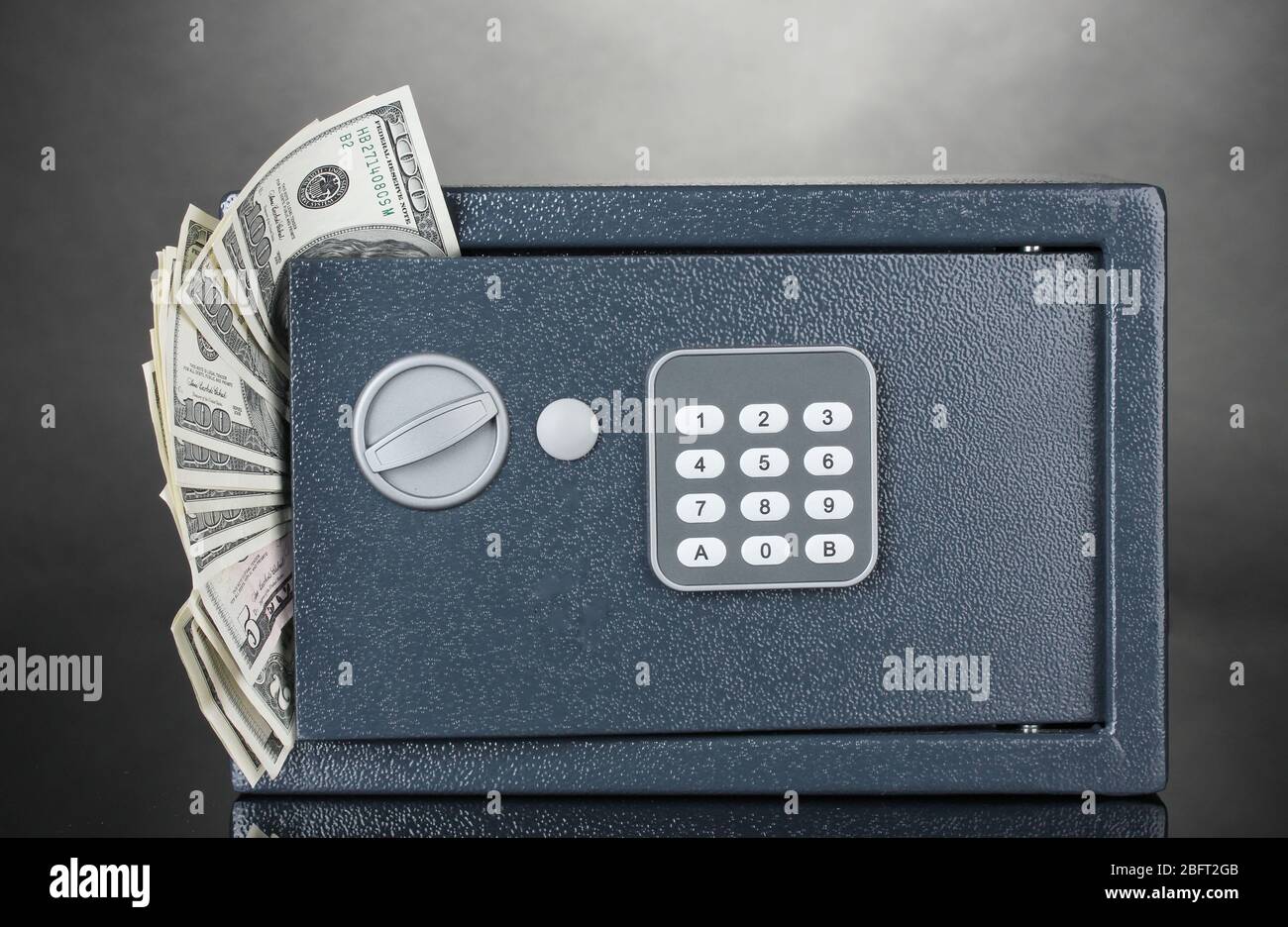 safe with dollars on grey background Stock Photo - Alamy
