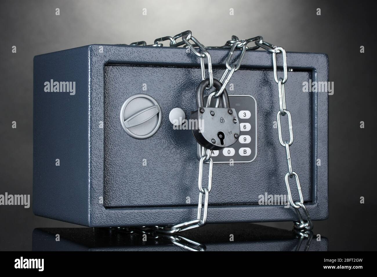 safe with chain and lock on grey background Stock Photo - Alamy