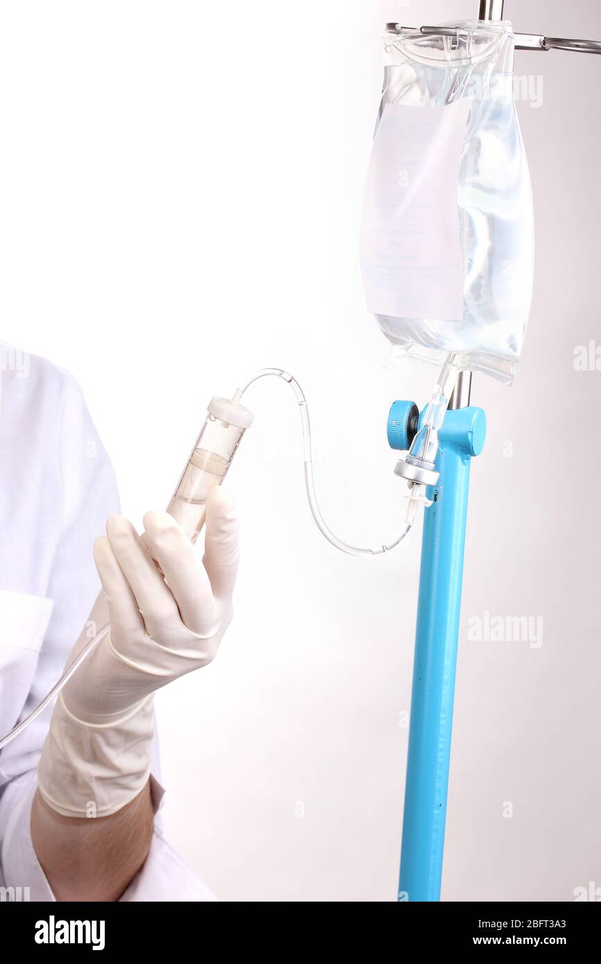 Nurse doing infusion isolated on white Stock Photo - Alamy