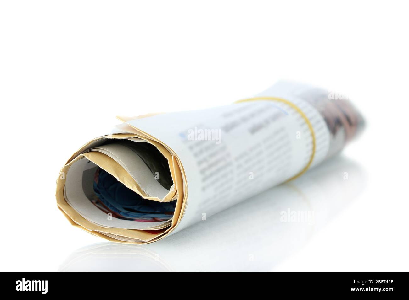 Roll of newspaper isolated on white Stock Photo - Alamy