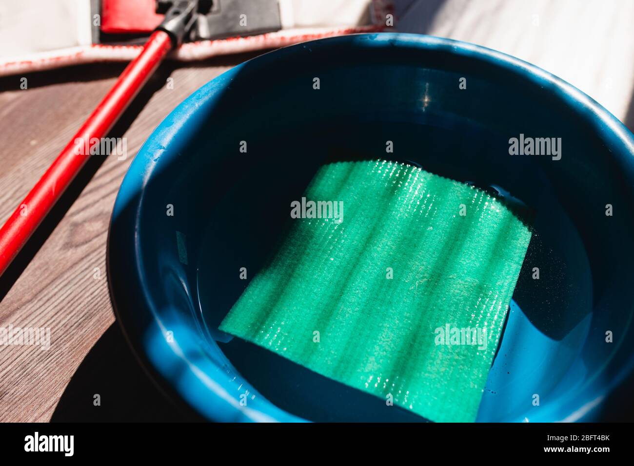 Blue water basin and floor mop Stock Photo - Alamy
