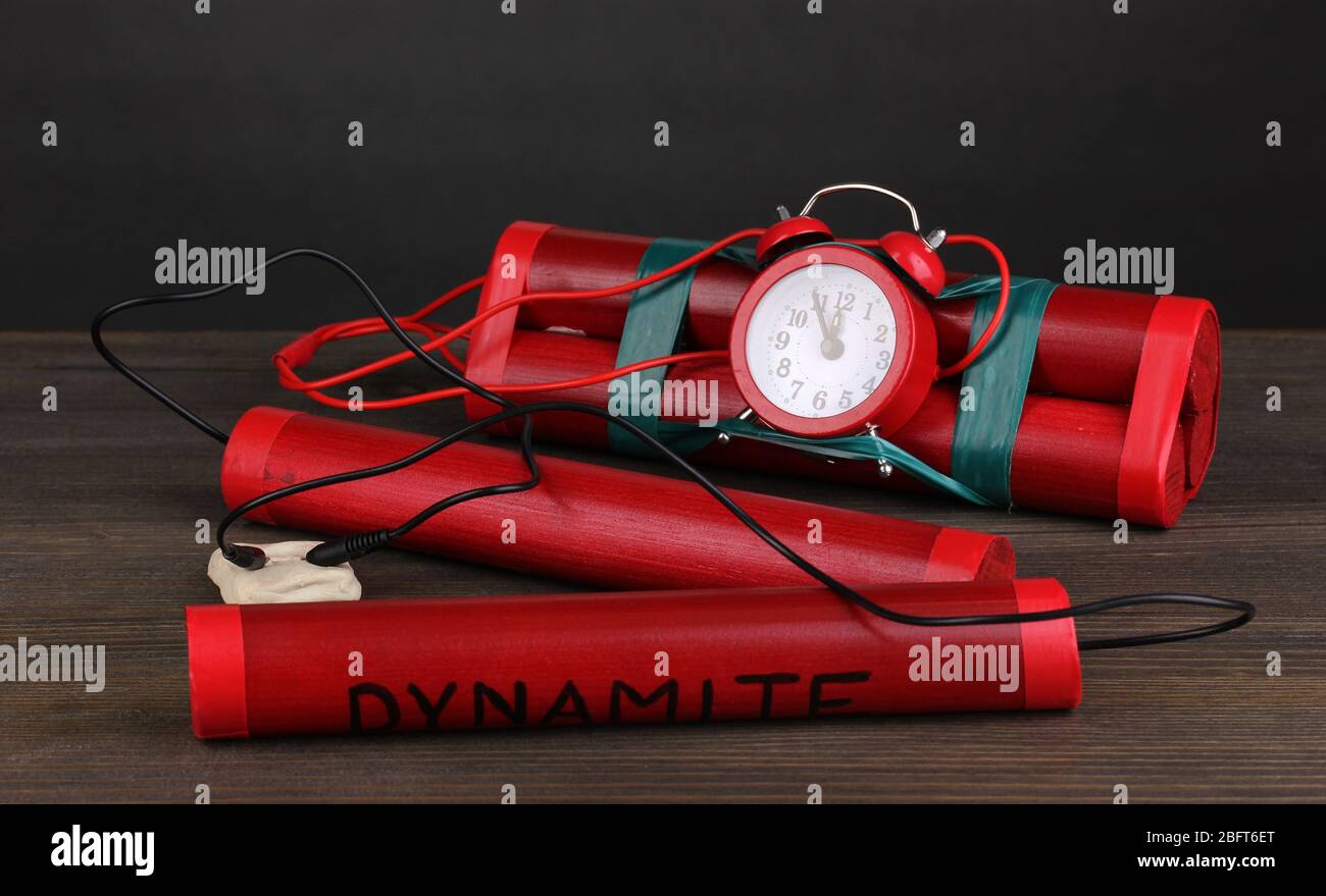 Timebomb made of dynamite on wooden table on grey background Stock ...