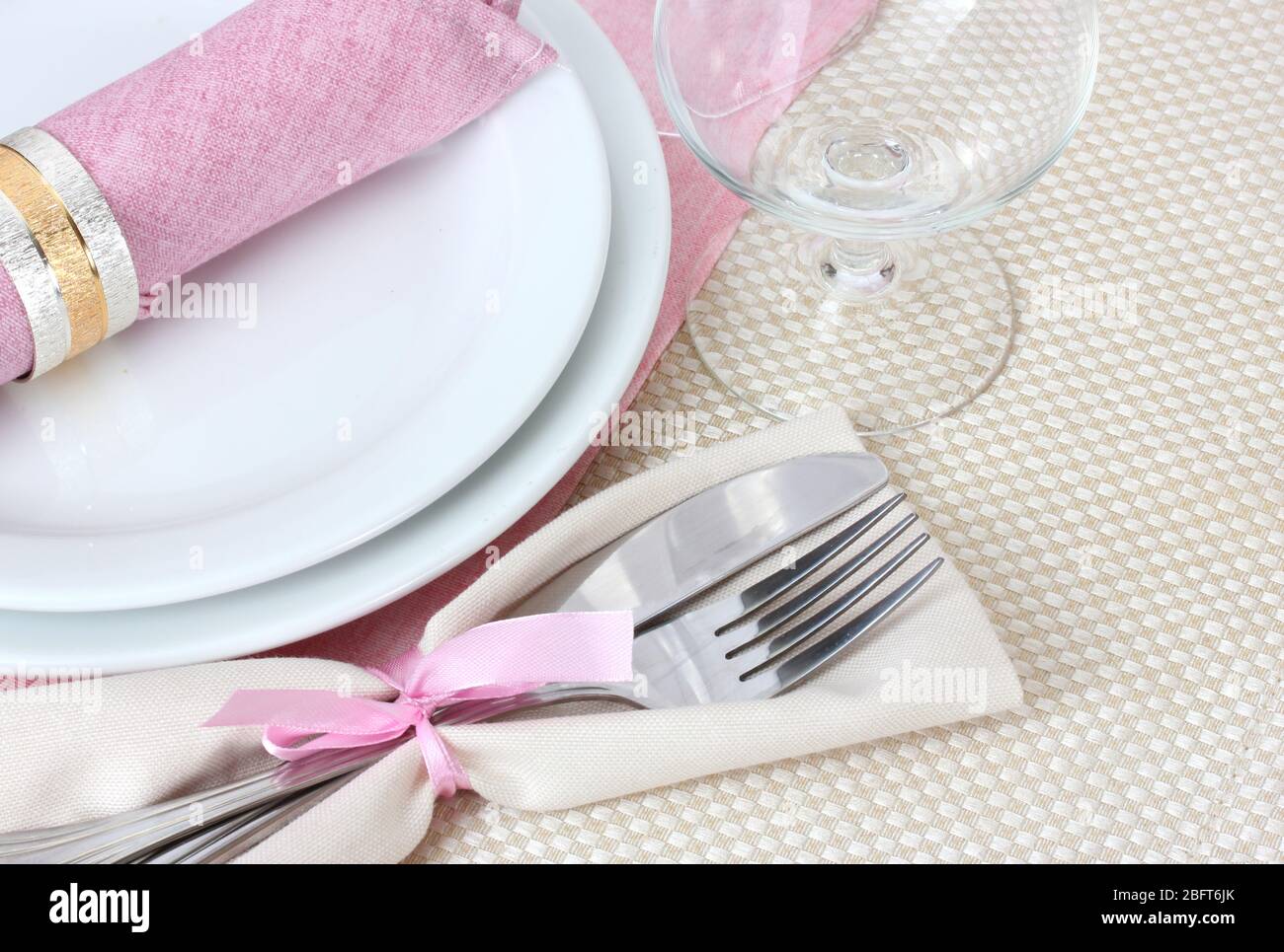 Table setting with fork, knife, plates, and napkin Stock Photo - Alamy