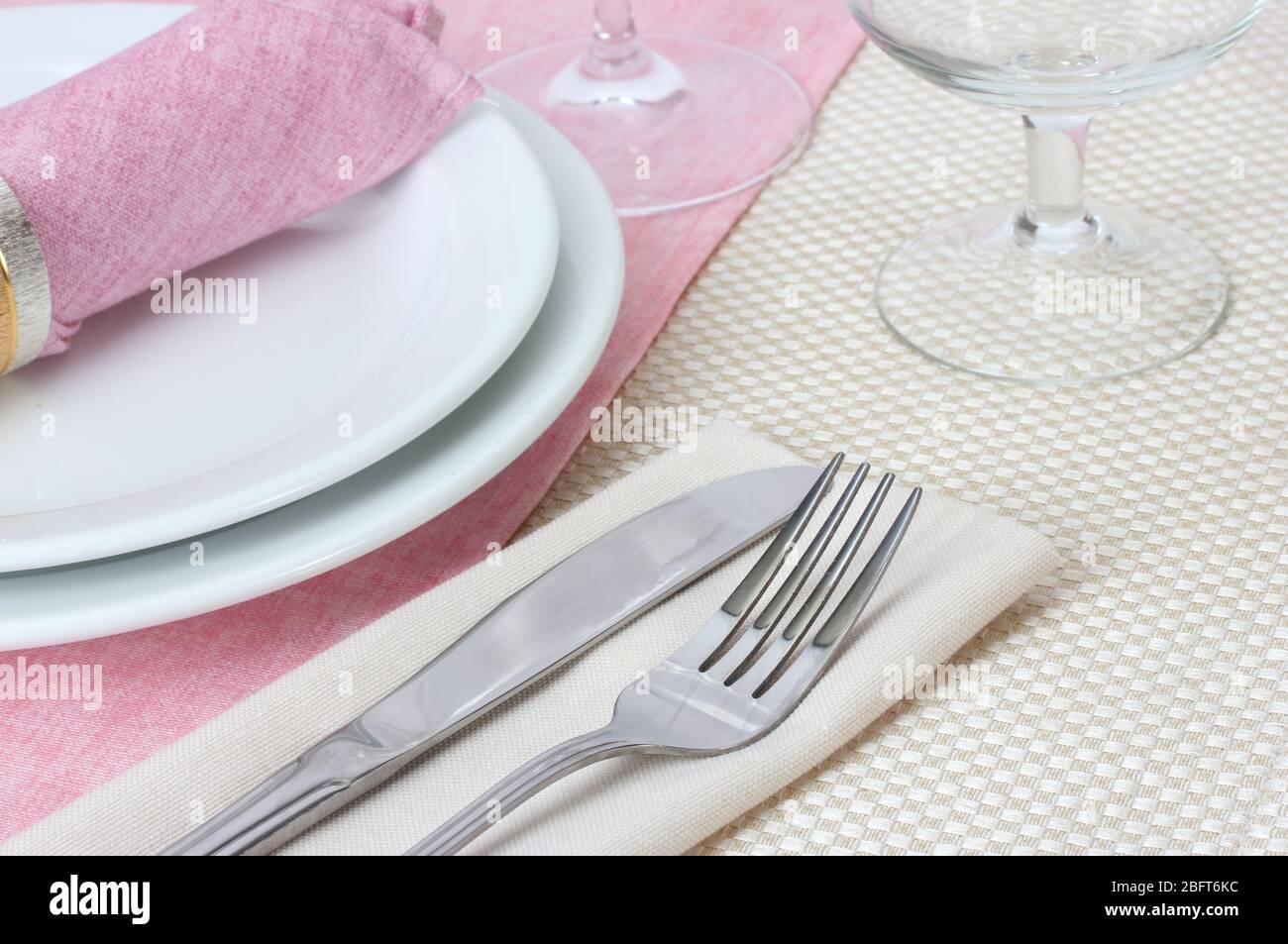 Table setting with fork, knife, plates, and napkin Stock Photo - Alamy