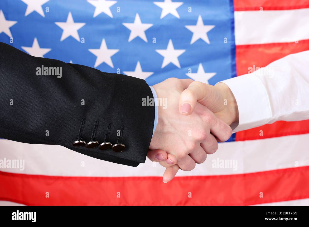 Business handshake on american flag background Stock Photo - Alamy