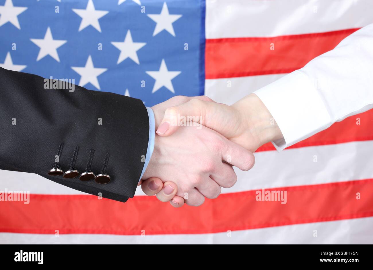 Business handshake on american flag background Stock Photo - Alamy