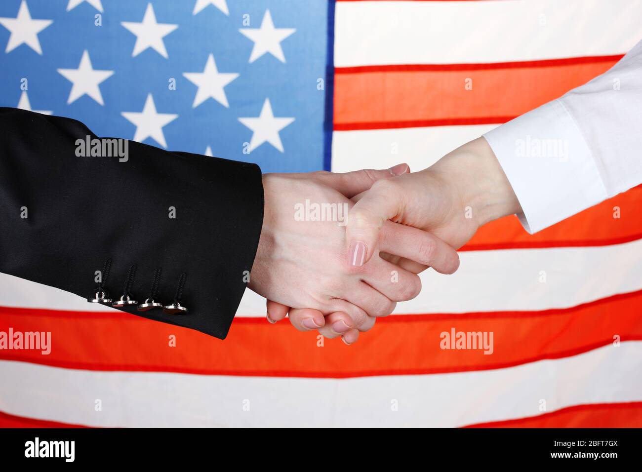 Business handshake on american flag background Stock Photo - Alamy