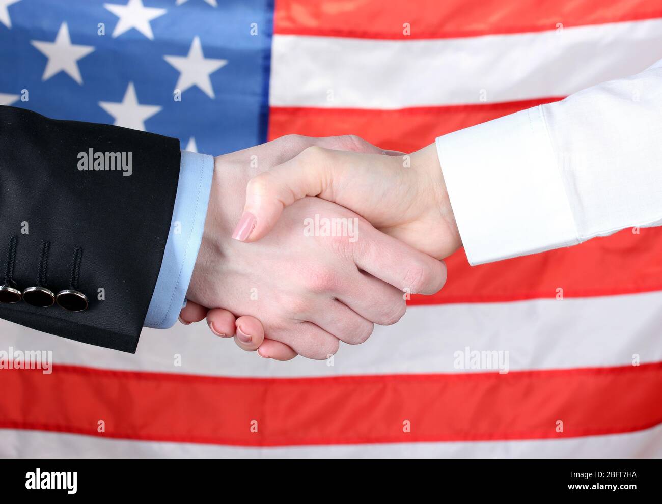 Business handshake on american flag background Stock Photo - Alamy