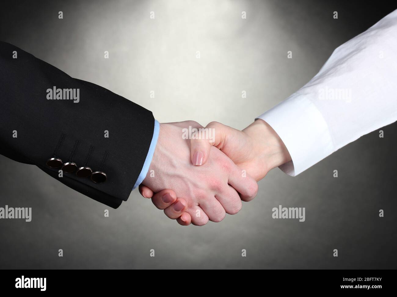 Business handshake on gray background Stock Photo - Alamy