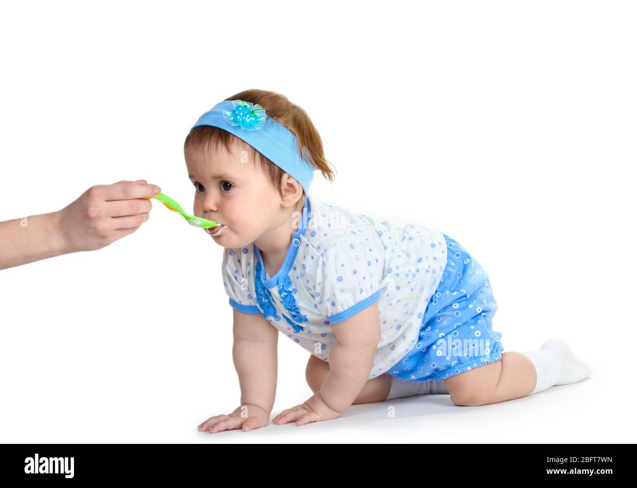 Cute baby girl eating isolated on white Stock Photo - Alamy