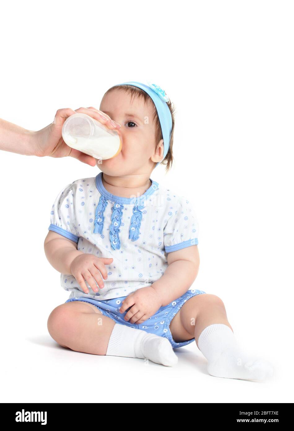 Cute baby girl eating isolated on white Stock Photo - Alamy