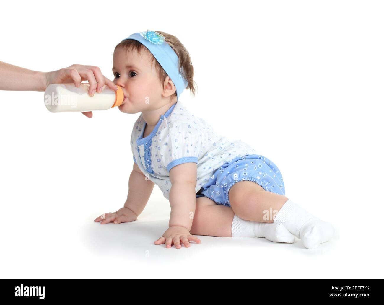 Cute baby girl eating isolated on white Stock Photo - Alamy