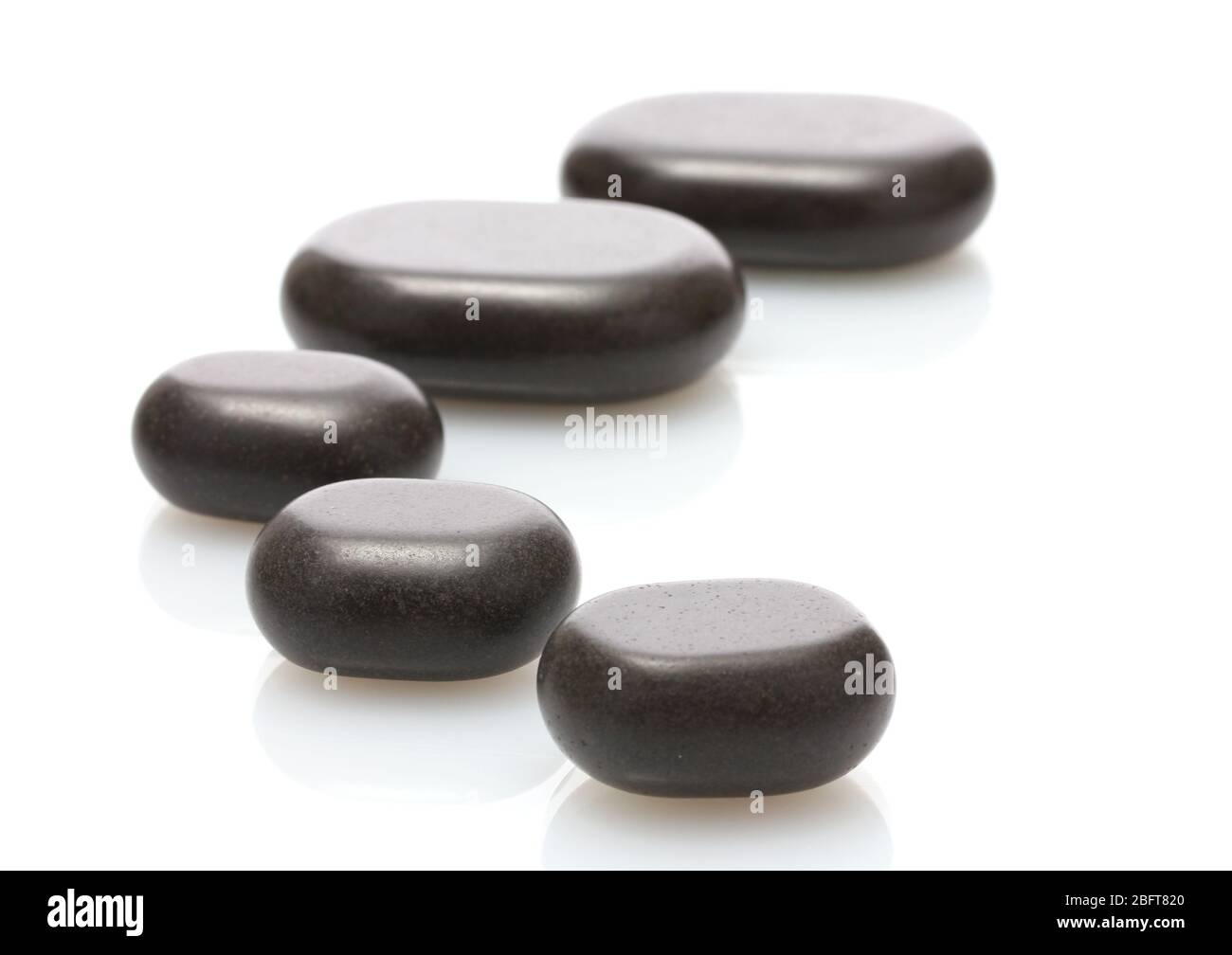 Spa stones isolated on white Stock Photo - Alamy
