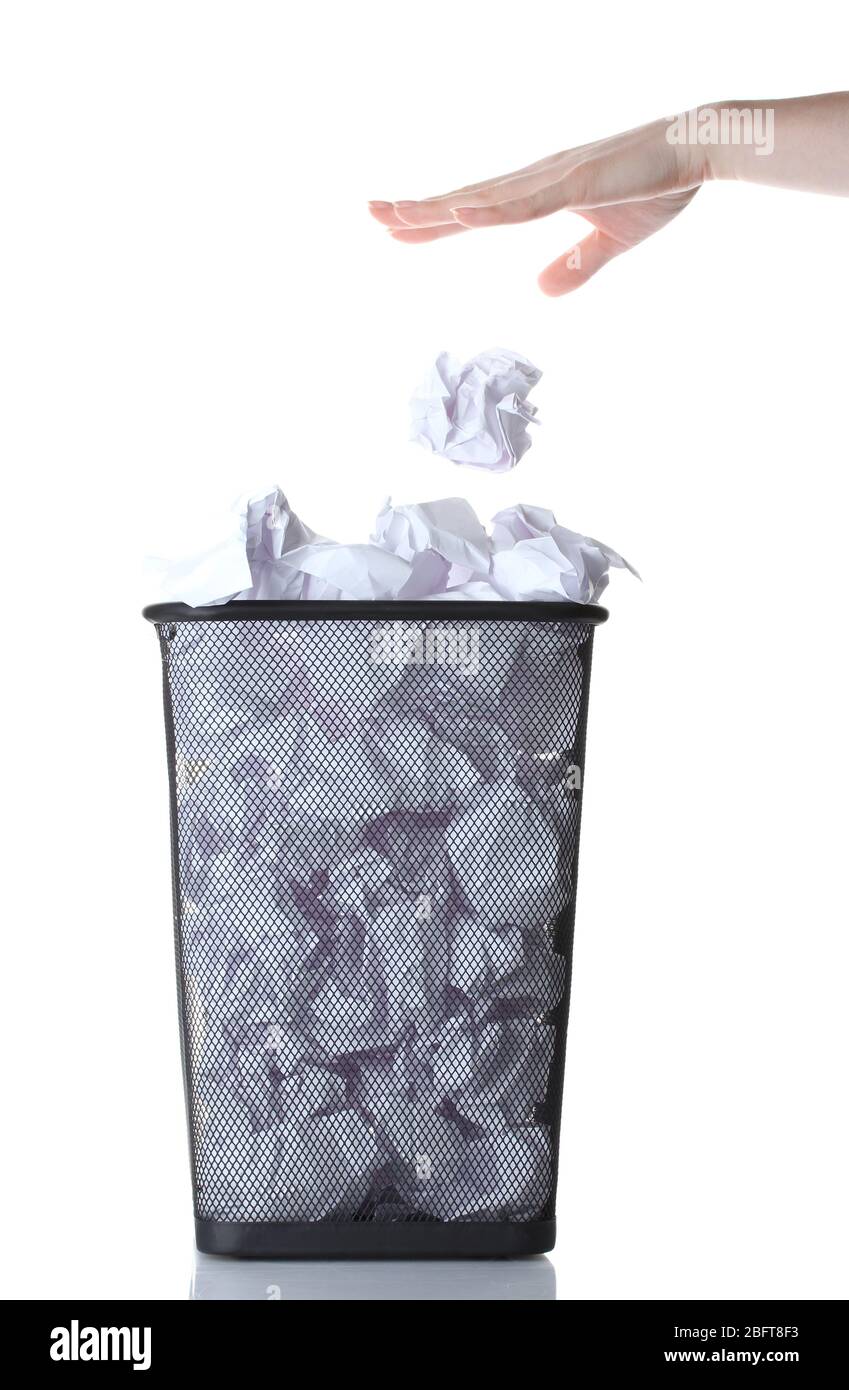 hand going garbage in metal trash bin from paper isolated on white ...