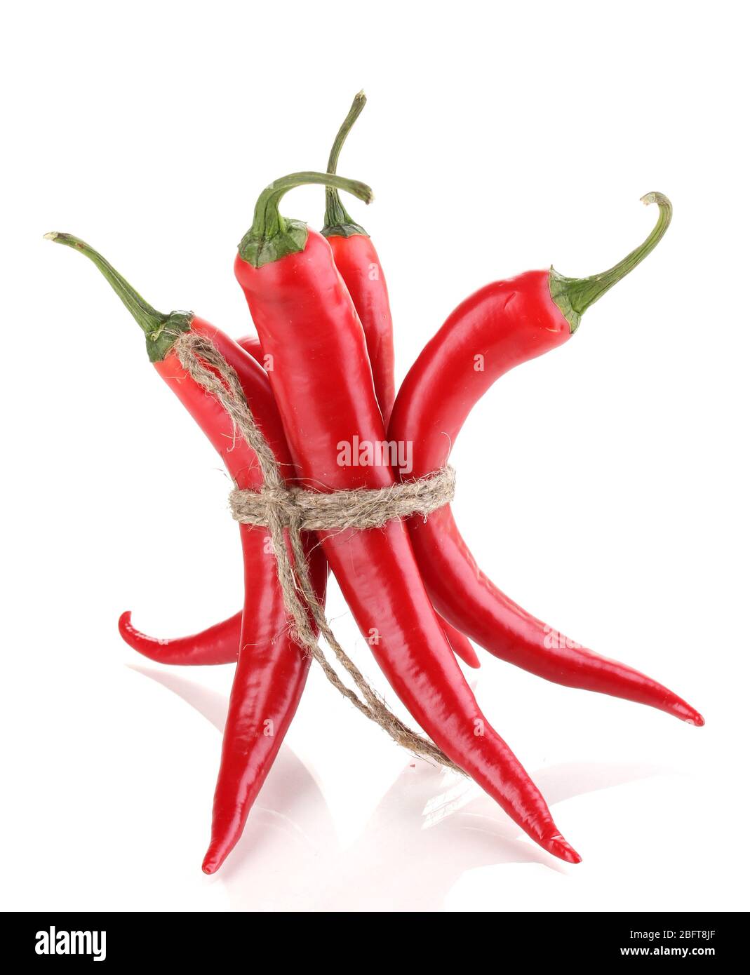 Red hot chili peppers tied with rope isolated on white Stock Photo - Alamy