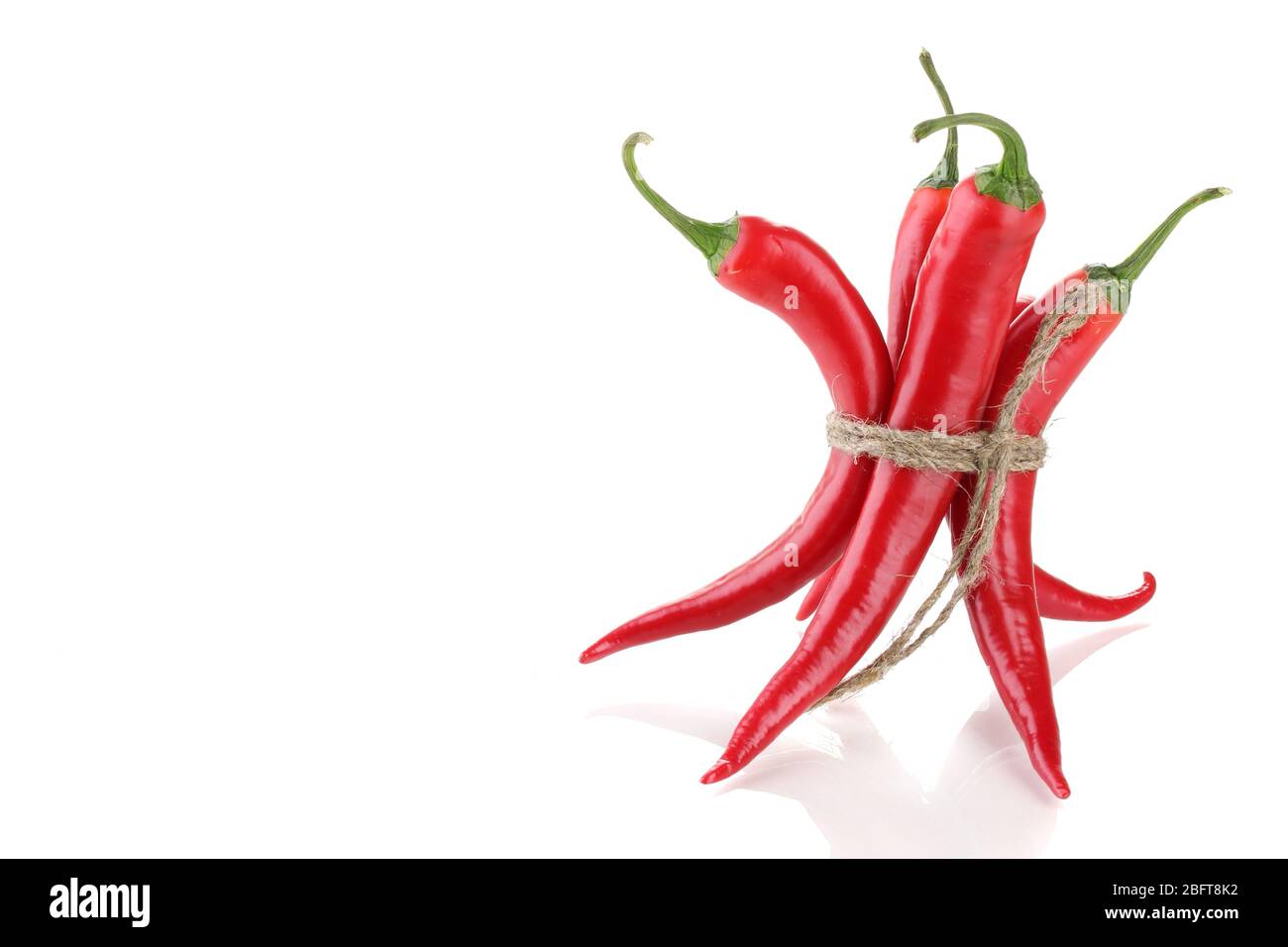 Red hot chili peppers tied with rope isolated on white Stock Photo - Alamy