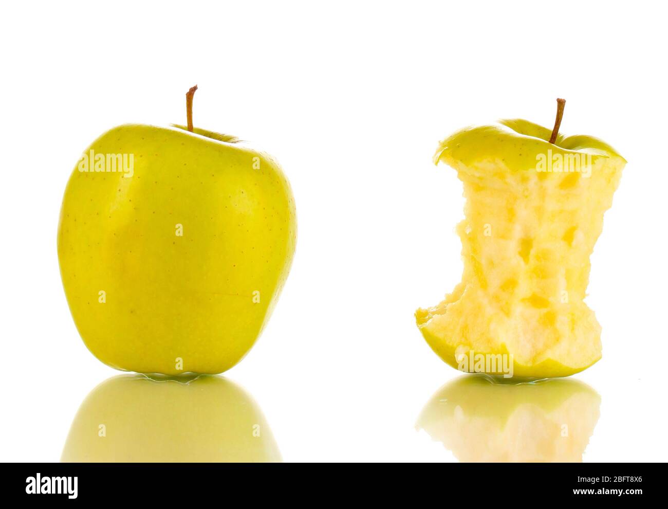 Green bitten apple and whole apple isolated on white Stock Photo - Alamy