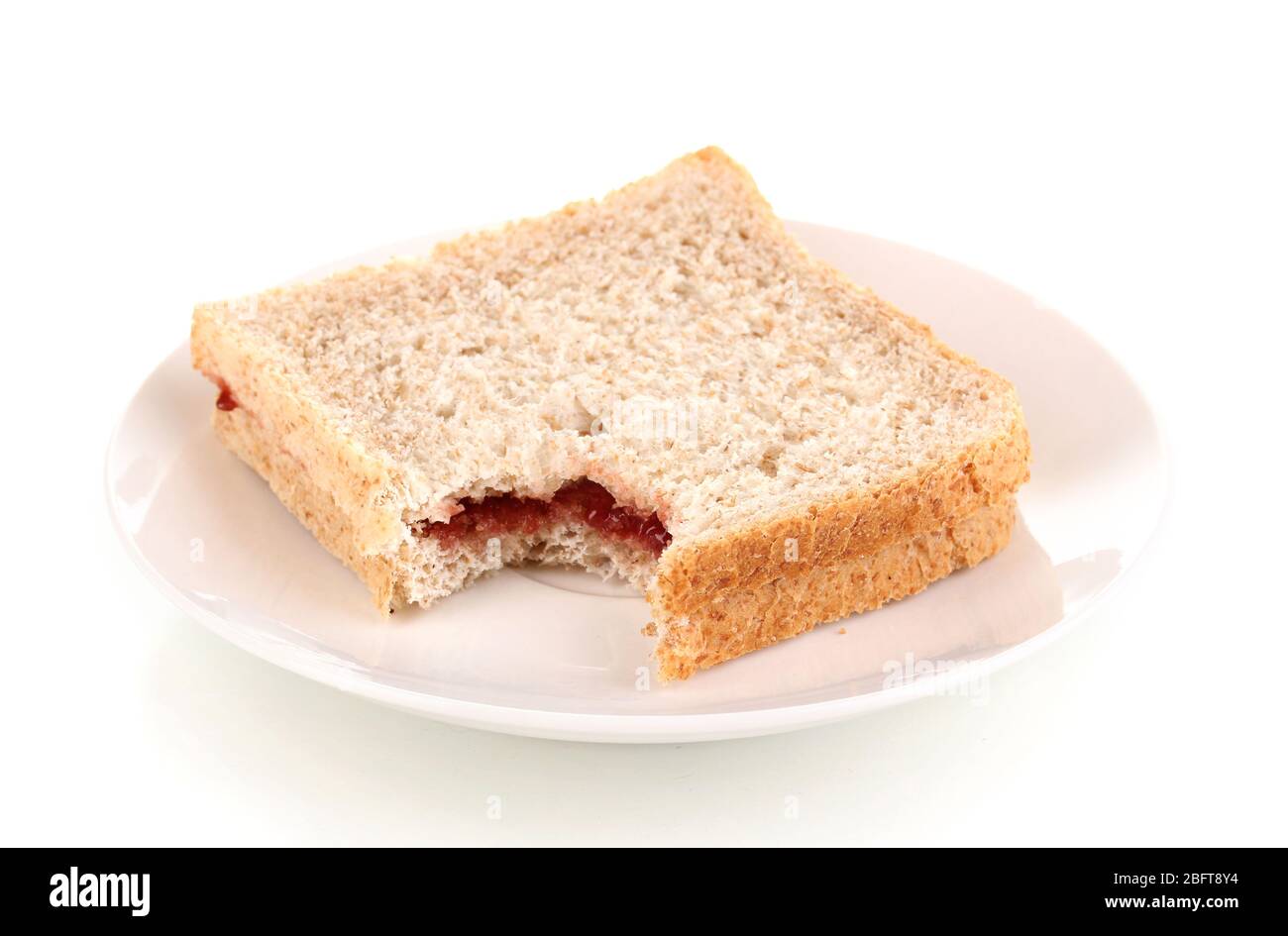 Bitten sandwich with jam on plate isolated on white Stock Photo - Alamy