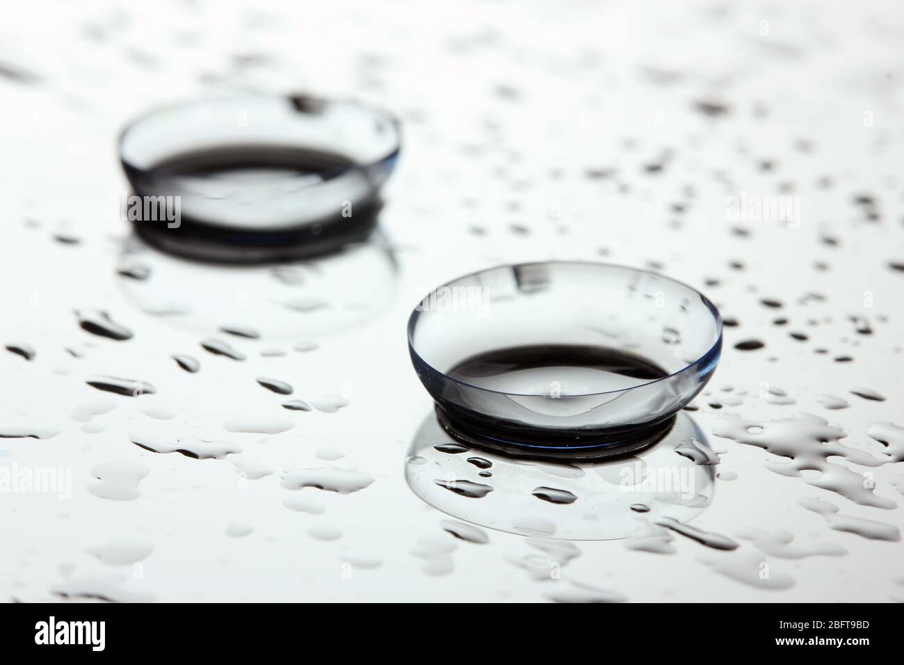 contact lens with drops on white background Stock Photo - Alamy