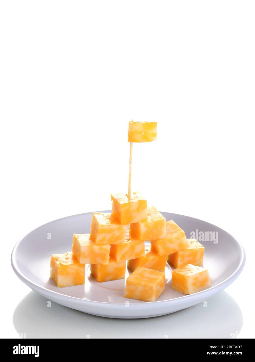 Cheese pyramid on plate isolated on white Stock Photo - Alamy