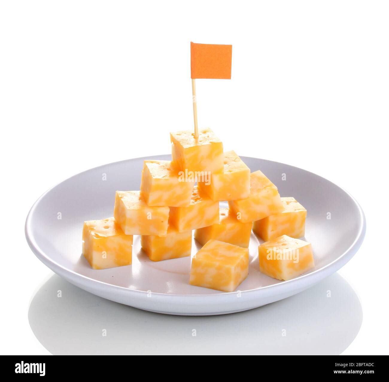 Cheese pyramid on plate isolated on white Stock Photo - Alamy