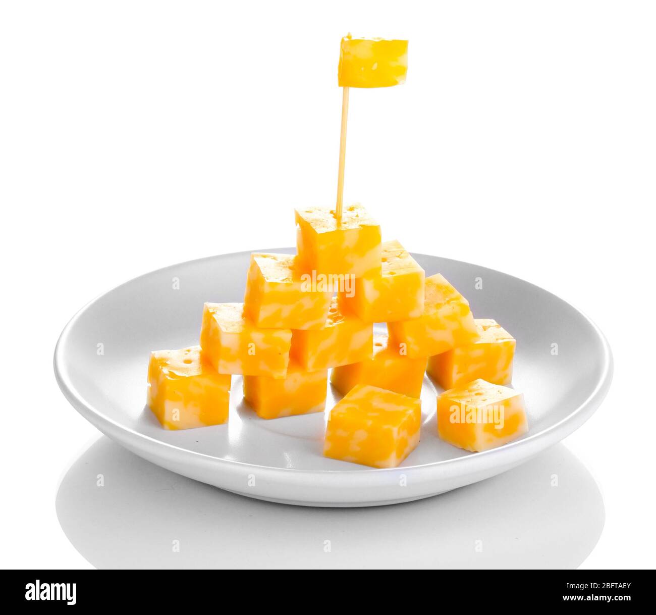 Cheese pyramid on plate isolated on white Stock Photo - Alamy