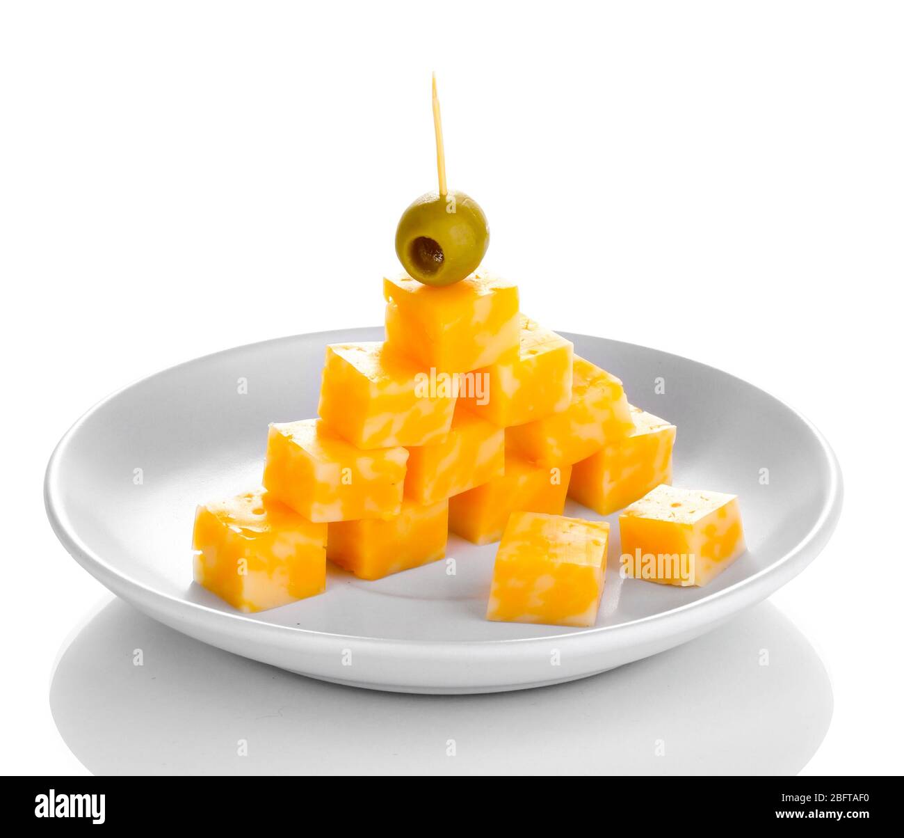 Cheese pyramid on plate isolated on white Stock Photo - Alamy