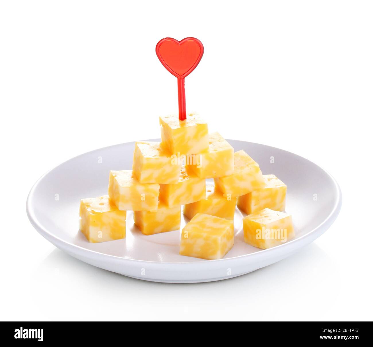 Cheese pyramid on plate isolated on white Stock Photo - Alamy