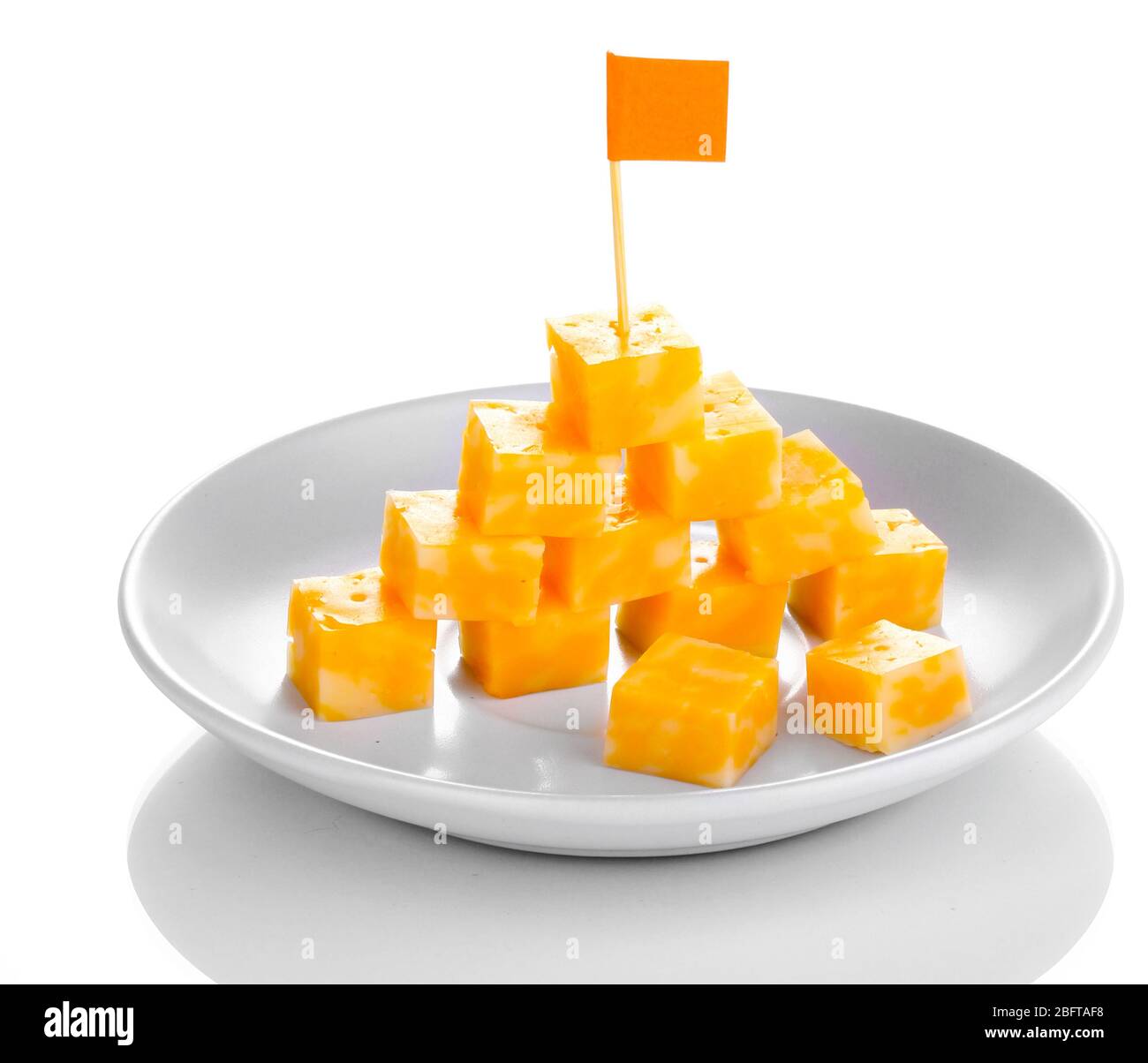 Cheese pyramid on plate isolated on white Stock Photo - Alamy