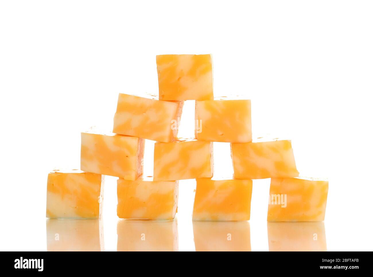 Cheese pyramid isolated on white Stock Photo - Alamy