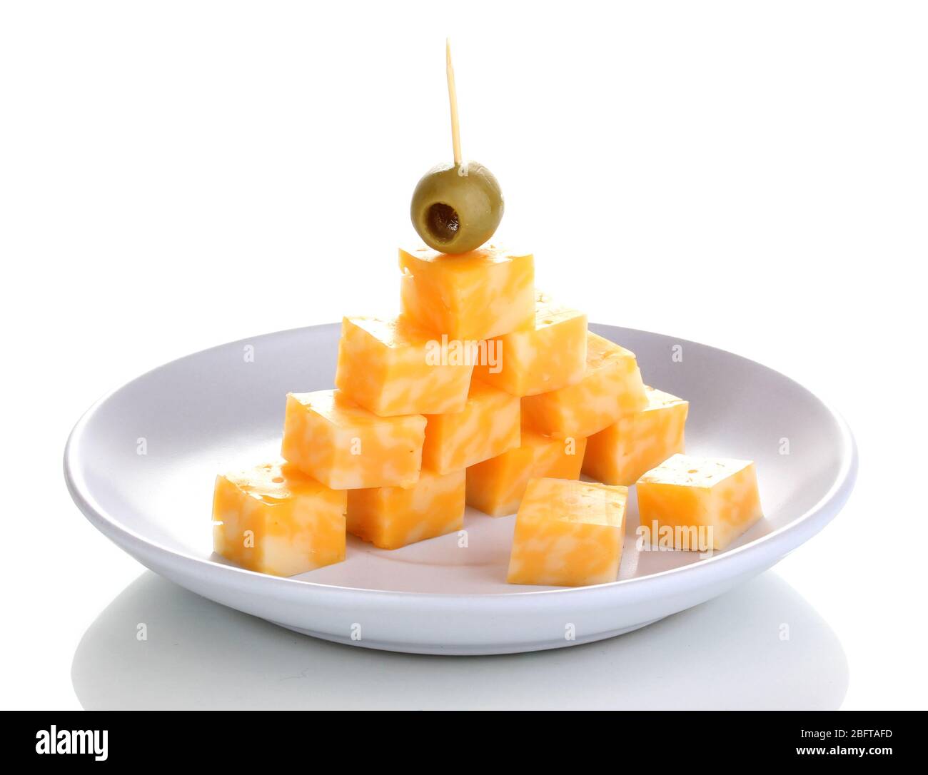 Cheese pyramid on plate isolated on white Stock Photo - Alamy