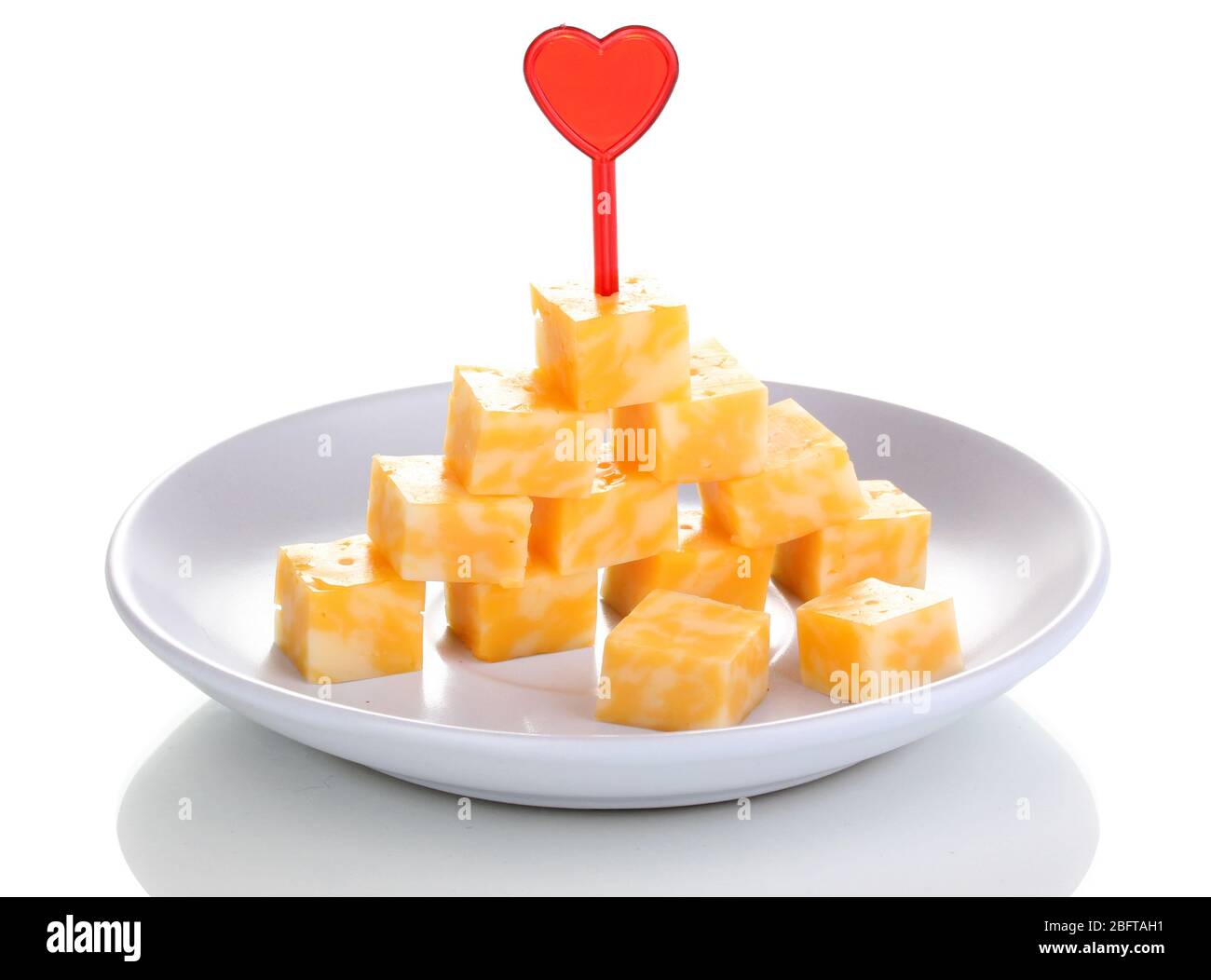 Cheese pyramid on plate isolated on white Stock Photo - Alamy
