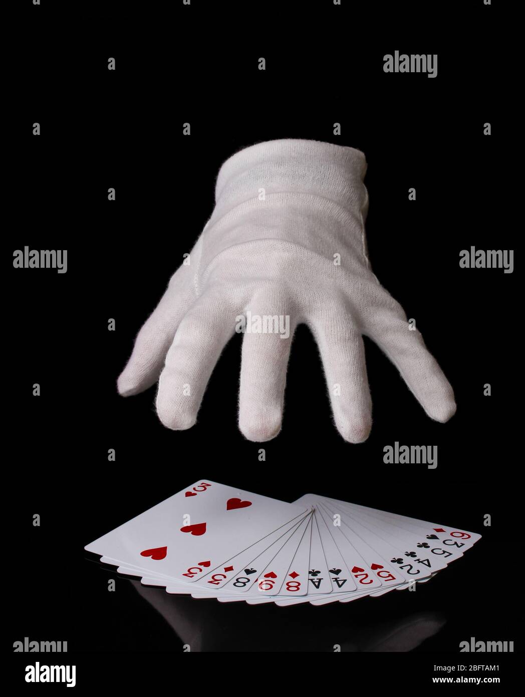 Cards and hand isolated on black Stock Photo - Alamy