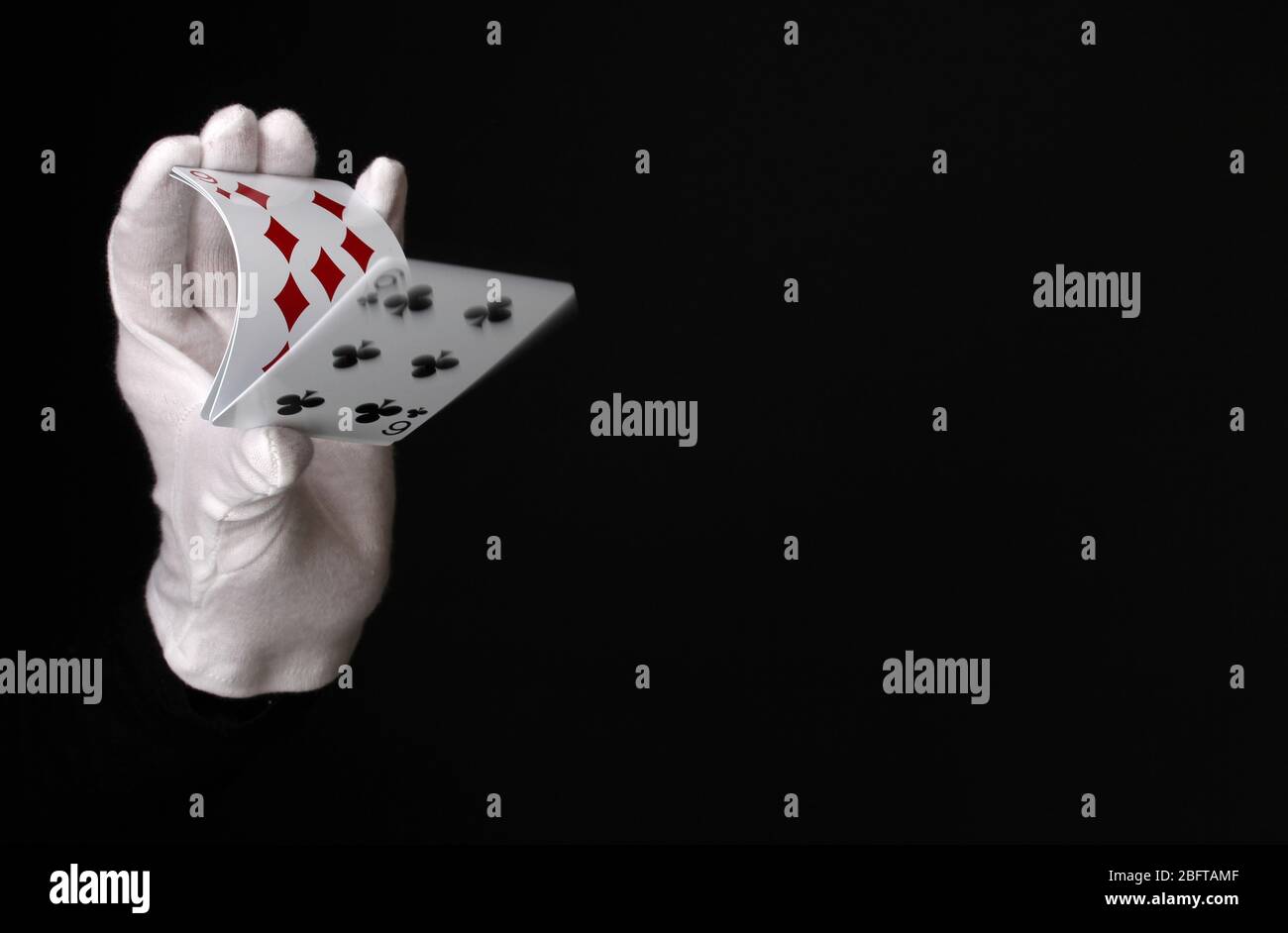 Cards in hand isolated on black Stock Photo - Alamy