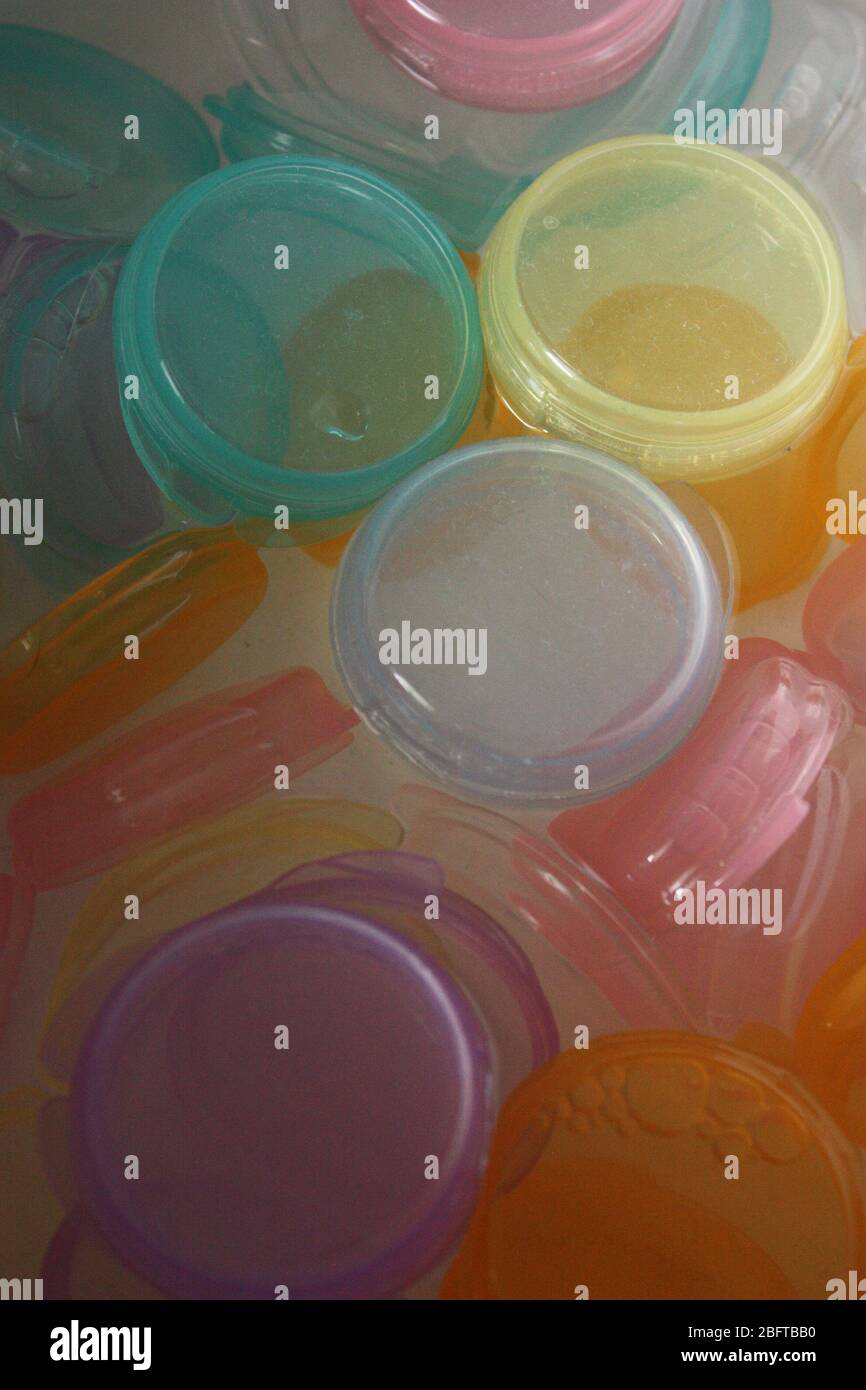 Small, round plastic containers in water Stock Photo - Alamy